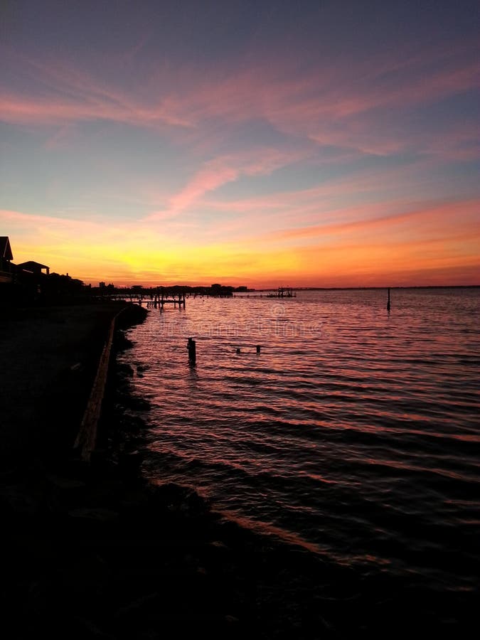 Sunset over the bay stock photo. Image of colorful, orange - 126391040