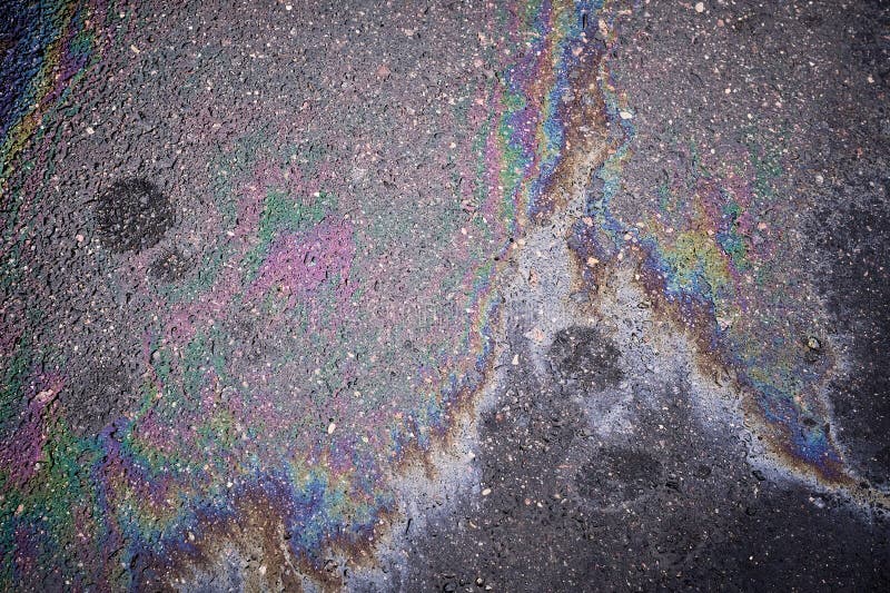 Colorful Gasoline or Oil Spill Creating a Rainbow Pattern on Asphalt ...