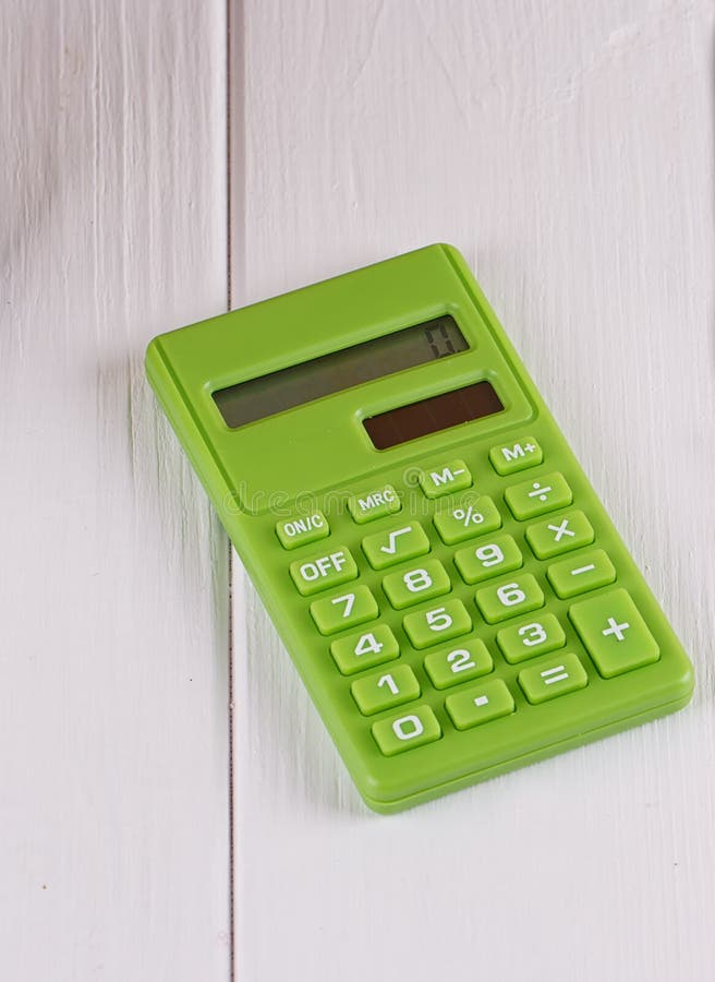 Colorful Green Plastic Calculator on White Wooden Table Stock Photo ...