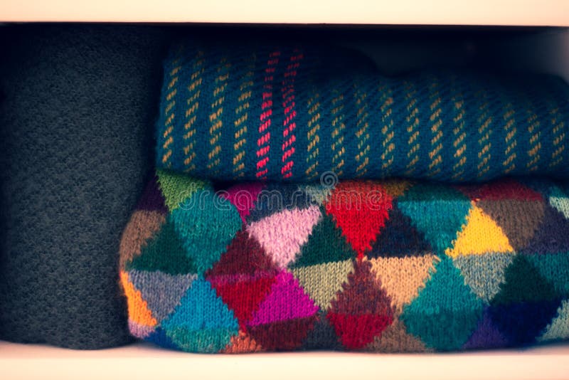Colorful Hand Knitted Wool Sweaters Folded in a Wardrobe Stock Photo ...