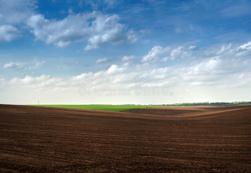 Hills of Plowed Dark Land and Green Fields Panoramic View Stock Photo ...