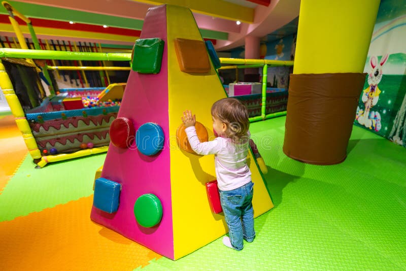 A Colorful Indoor Playground with a Soft Climbing Wall for Kids Fun and ...