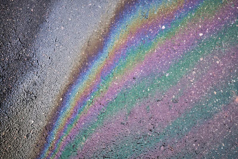 Colorful Iridescent Trace of Oil or Gasoline on Asphalt Surface. Stock ...