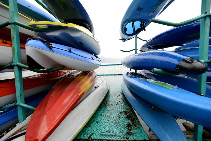 Colorful Kayaks and Canoes in a Row Stack Stock Photo - Image of ...