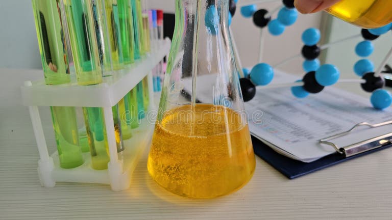 Colorful Laboratory Experiment with Yellow Solution in Flask and Test ...