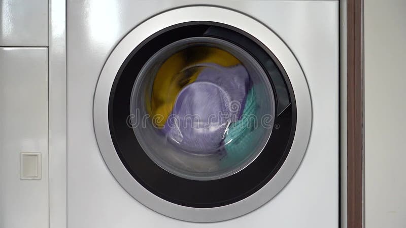 Colorful Laundry Inside a Front Loader Washing Machine Spinning Counter ...
