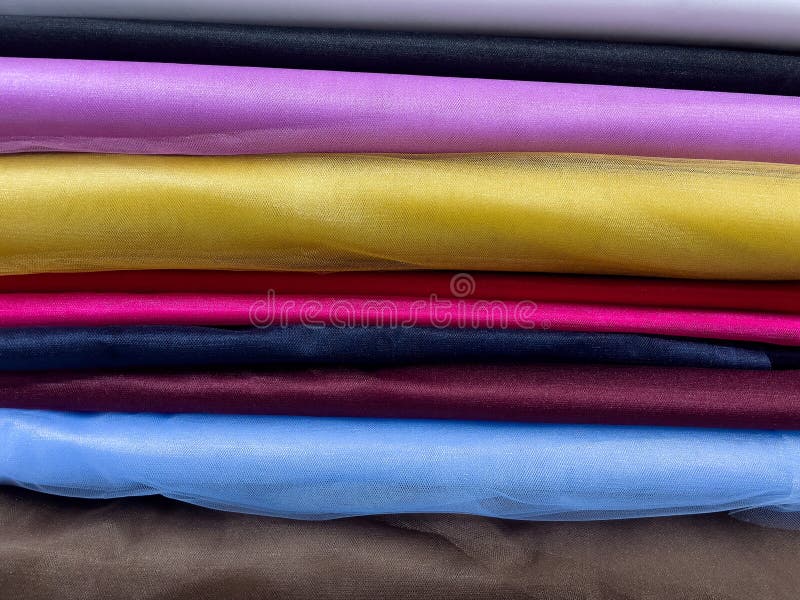 Colorful Layers of Fabric Rolls Displayed in a Stack, Perfect for ...