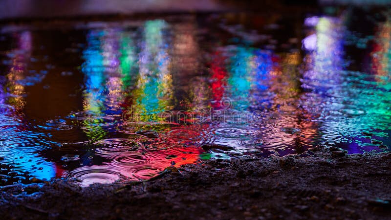 Reflection of Colorful Lights in Puddle As a Background Stock Image ...