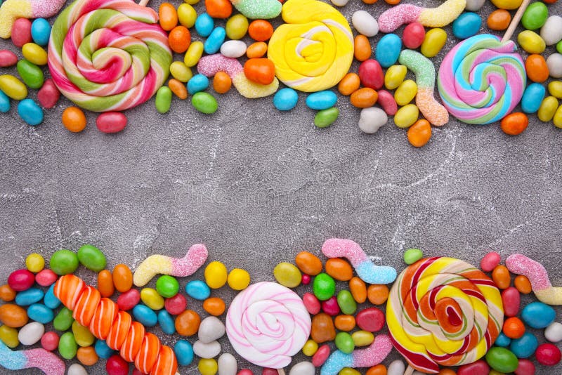 Colorful Lollipop and Different Colored Round Candy on Grey Concrete ...
