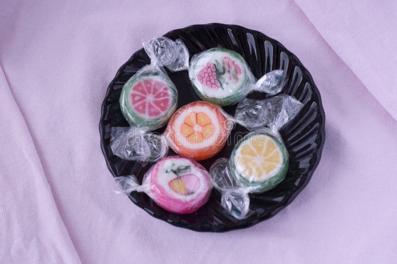 Colorful Lollipops and Different Colored Fruit Round Candy in Wrapper ...