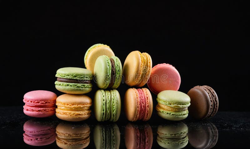 Colorful Macarons Arranged on a Black Surface Reflect Light Stock Photo ...