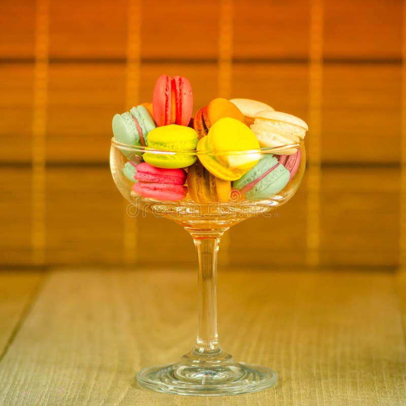 Colorful Macaroons in Glass on Wooden Table, Sunset Time Stock Photo ...