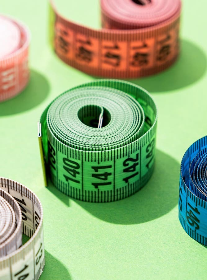 Colorful Measuring Tapes on Bright Green Background Stock Photo - Image ...