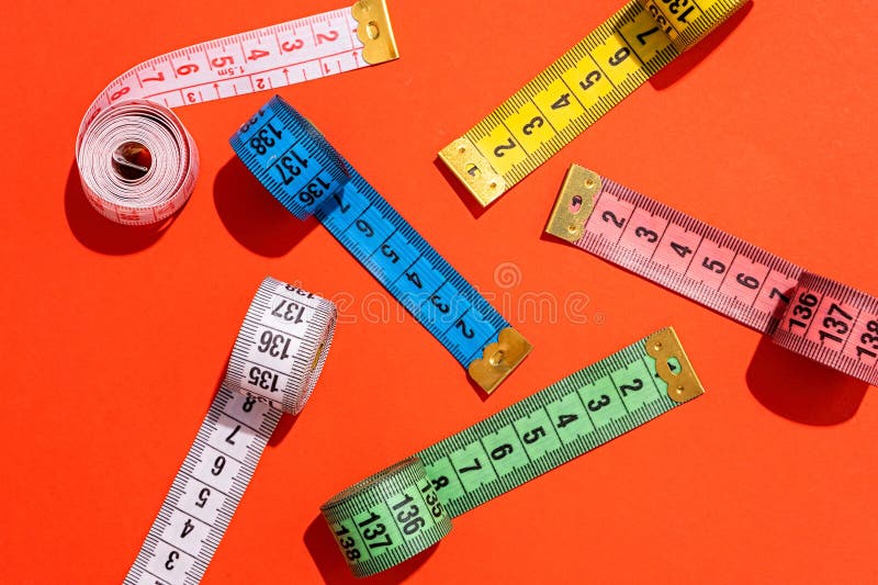 Colorful Measuring Tapes Top View on Bright Red Background Stock Image ...