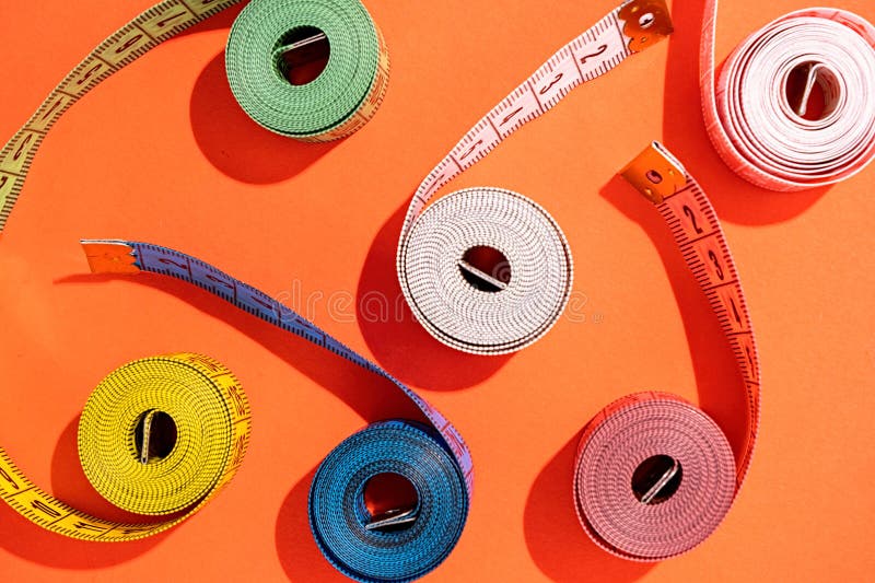 Colorful Measuring Tapes Top View on Bright Red Background Stock Image ...