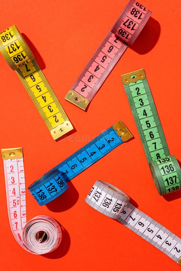 Colorful Measuring Tapes Top View on Bright Red Background Stock Image ...