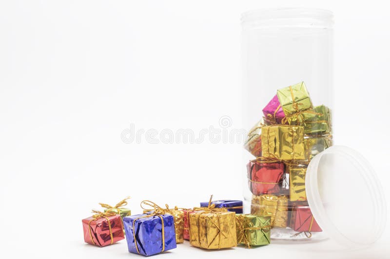 Colorful Miniature Gift Boxes Lie in a Clear Plastic Jar and on Its ...
