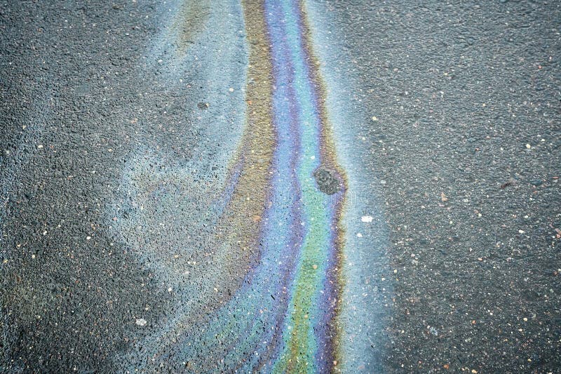 Colorful Oil Sheen on Pavement Creates Striking Visual Effect in Urban ...