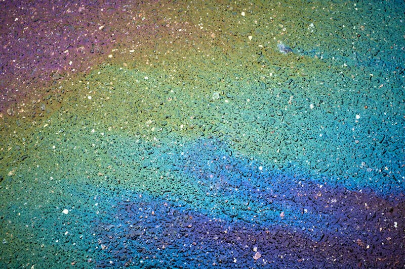 Colorful Oil Spill Creating Rainbow Patterns on Asphalt. Stock Photo ...