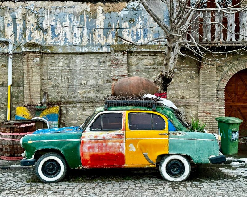 Colorful Old Car Parked Next To an Old and Messy Wall. Stock Photo ...