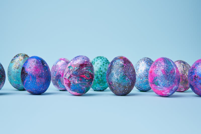 Colorful Painted Shiny Eggs on Blue Background. Stock Photo - Image of ...