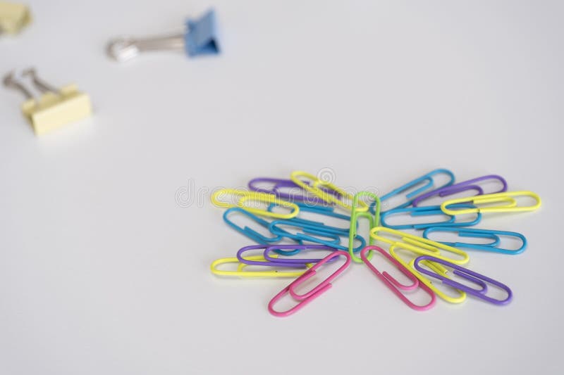 Colorful Paper Clips Arranged in a Decorative Pattern on a White ...