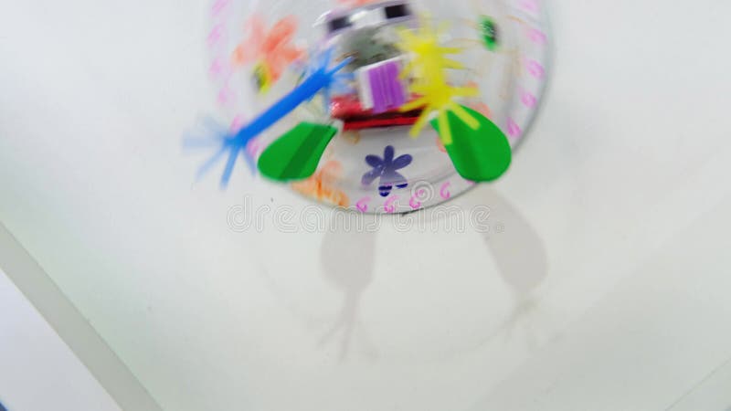 Colorful Paper Plate Spinning on White Surface in Slow Motion Stock ...
