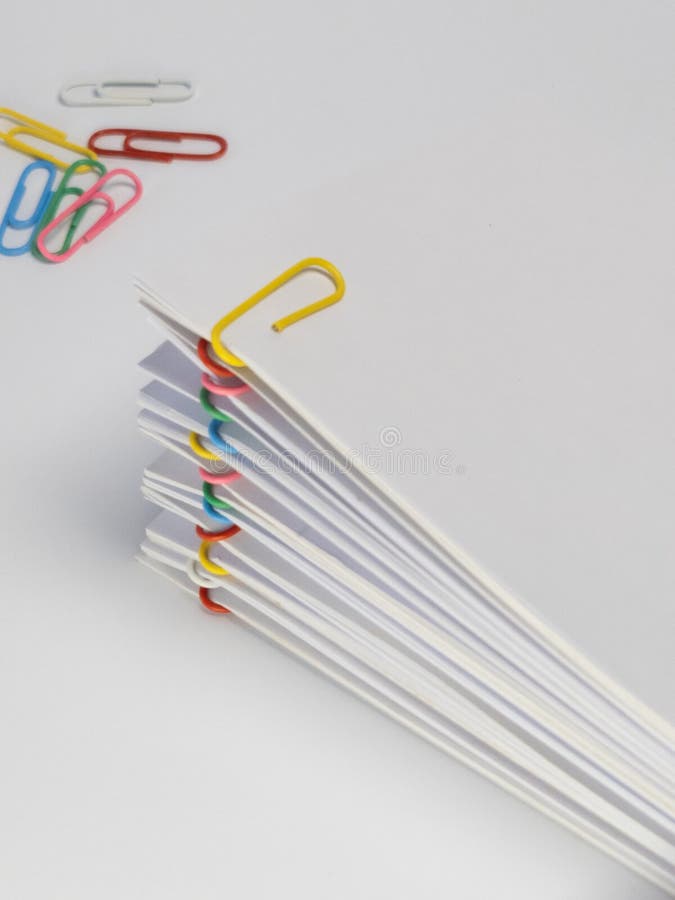 Colorful Paperclips Secure Stack of White Paper Documents on White ...