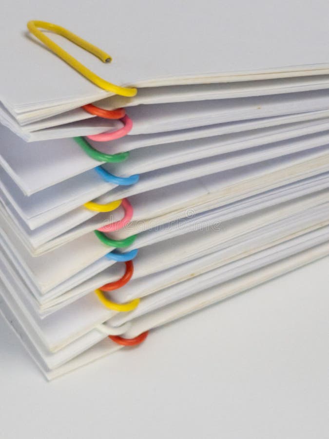Colorful Paperclips Securing a Stack of Documents on a White Background ...