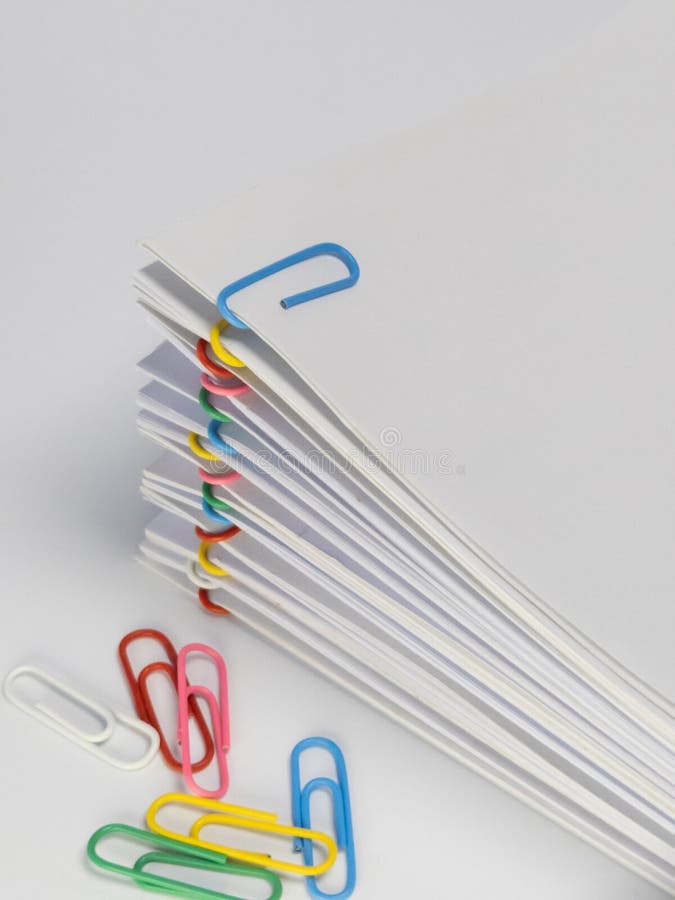 Colorful Paperclips and Stacked Documents on a White Background Stock ...