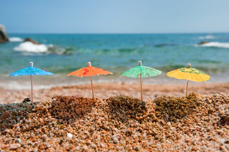 Colorful Parasols In The Grass Stock Image - Image of green, traveling ...