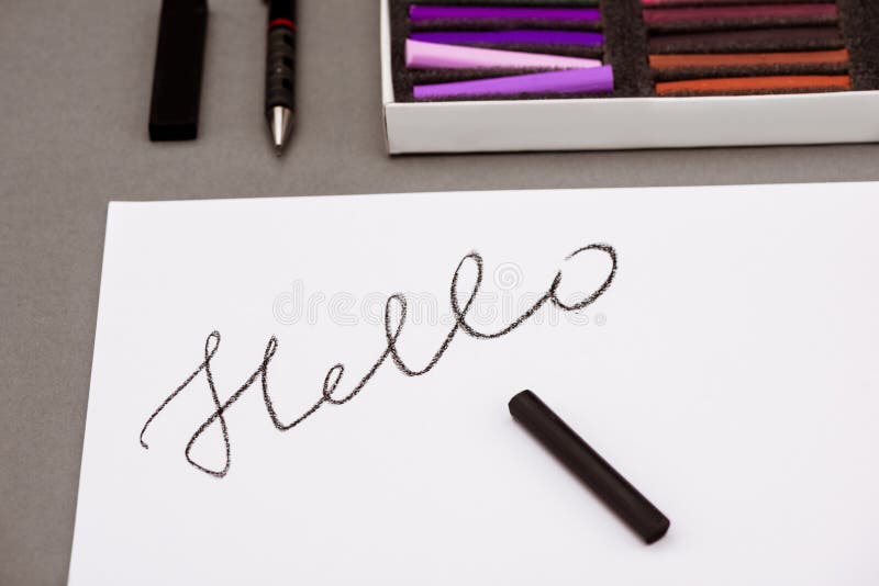 Colorful Pastel, Pen, Paper with Word Hello on Grey Table. Stock Image ...