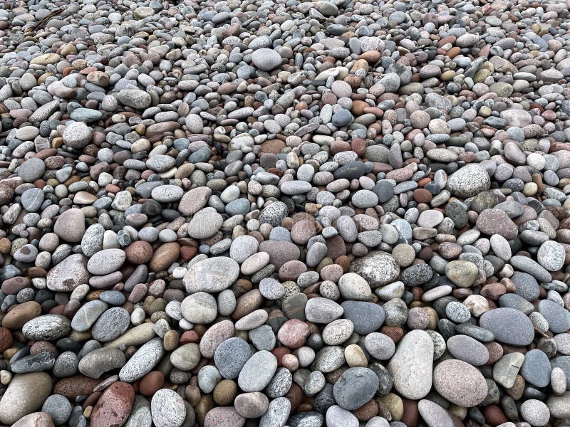 Colorful Pebbles Scattered Along a Beach Create a Natural Mosaic Under ...