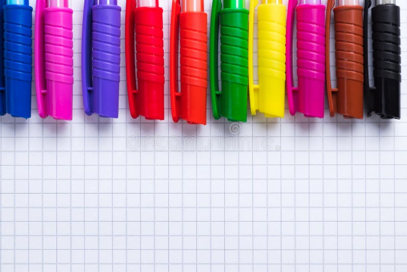 Colorful Pens in a Row on Sheet of Squared Paper Stock Photo - Image of ...