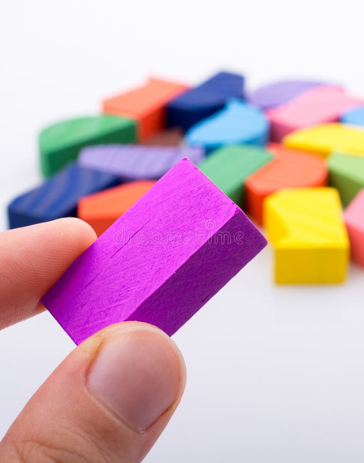Colorful Pieces of a Logic Puzzle in Hand Stock Photo - Image of ...