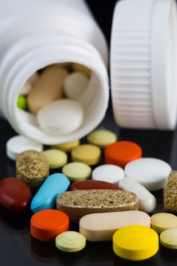 Colorful Pills Scattered from White Bottle Stock Image - Image of ...