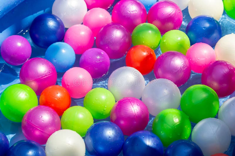 Colorful Plastic Balls Scattered in a Blue Pool Create a Vibrant Play ...