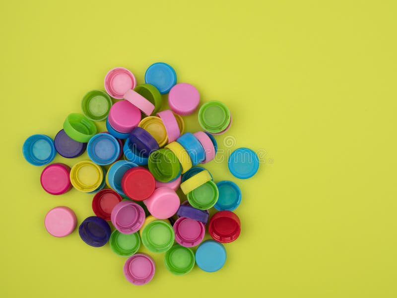 Colorful Plastic Caps for Bottles on a Bright Green Background Stock ...