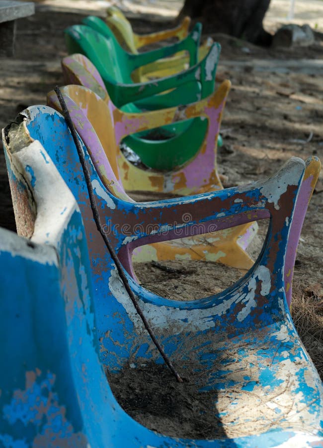 Colorful Plastic Chairs with Leaves in Autumn Stock Image - Image of ...
