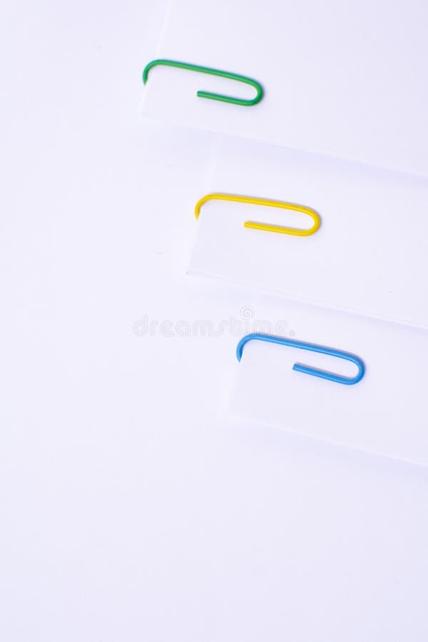 Colorful Plastic Paper Clips Attached To a Blank White Paper. Stock ...