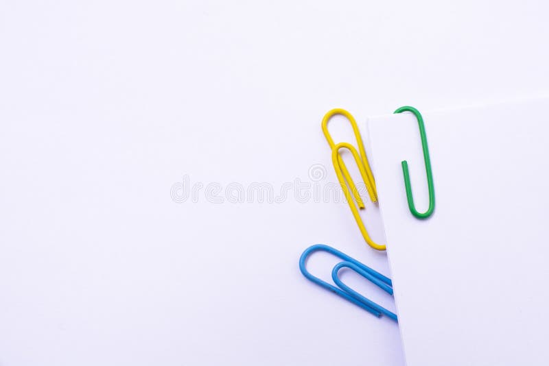 Colorful Plastic Paper Clips Attached To a Blank White Paper. Stock ...