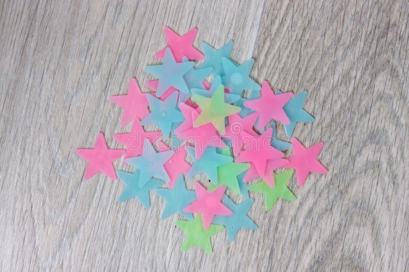 Colorful Plastic Stars on a Wooden Surface. Stock Image - Image of ...