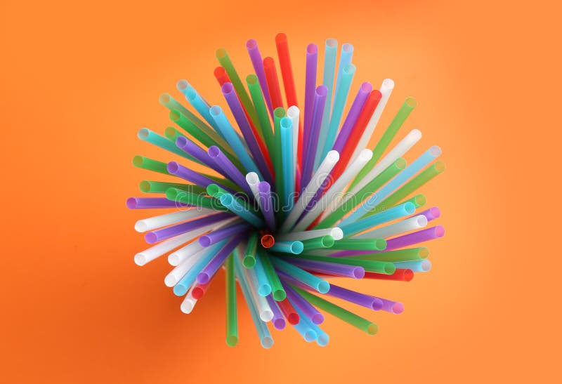 Colorful Plastic Straws for Drinks on Orange Background, Top View Stock ...
