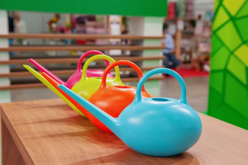 Colorful Plastic Watering Cans On Display In The Supermarket. Recycling ...