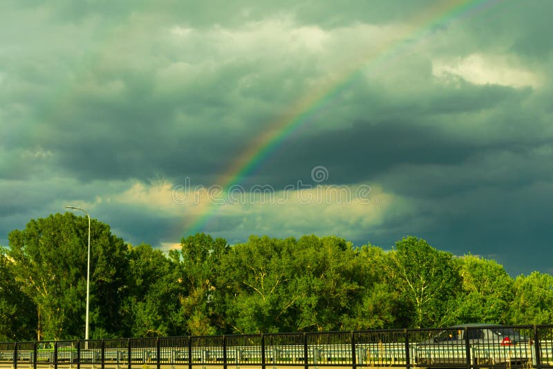 Colorful Rainbow Against the Backdrop of Thunderclouds, Clouds Over the ...
