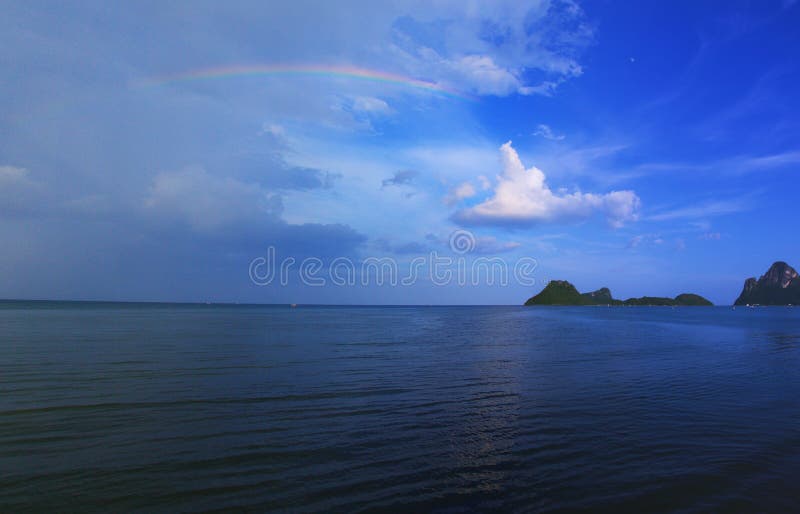Colorful rainbow at sea stock photo. Image of rainy, skyscape - 69257116