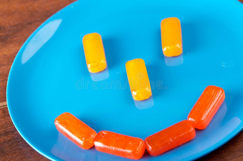 Colorful Rectangular Hard Candy Placed As Smiley Face on Blue Plate ...