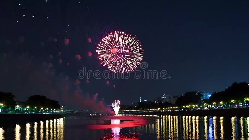 Colorful Red Fireworks Exploding Over City Riverside at Night Stock ...