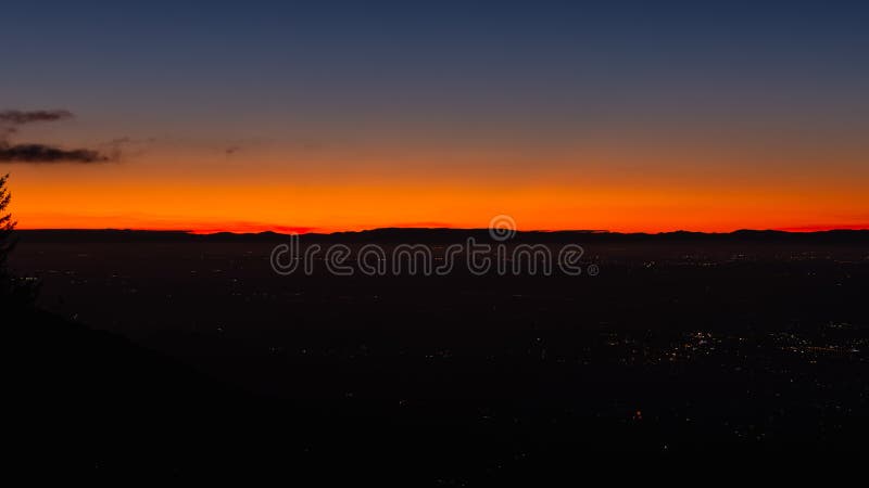 Colorful Red Sunset with Landscape of Cities Lights and Mountains on ...
