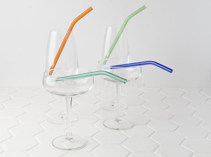 Colorful Reusable Glass Straws in the Glass on White Background. an ...